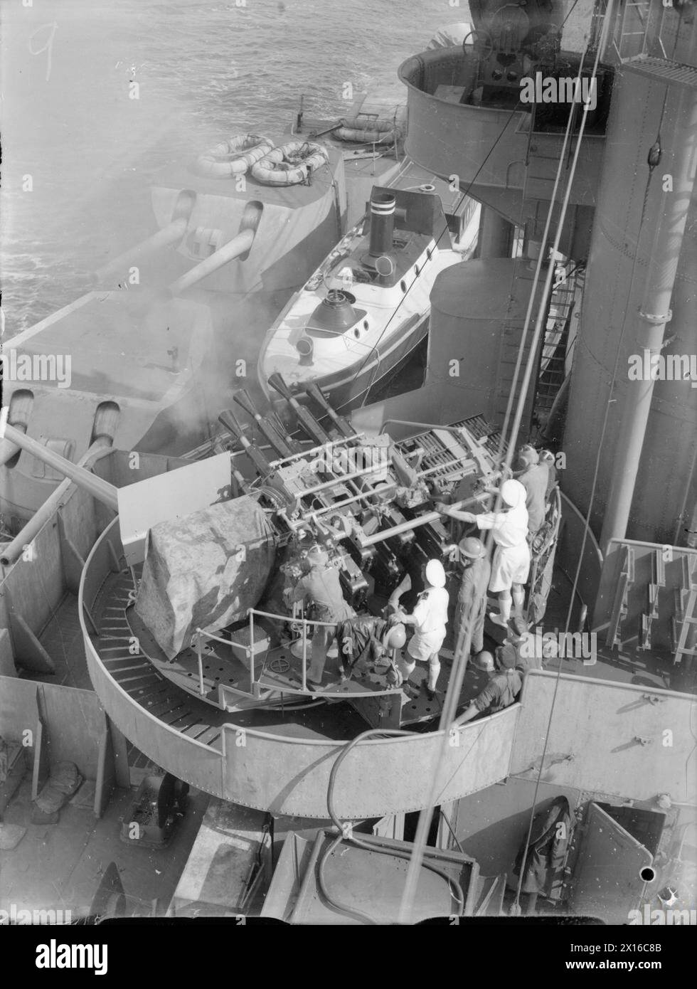 ON BOARD THE BATTLESHIP HMS RODNEY. 1941. - Gunnery practice with a pom ...