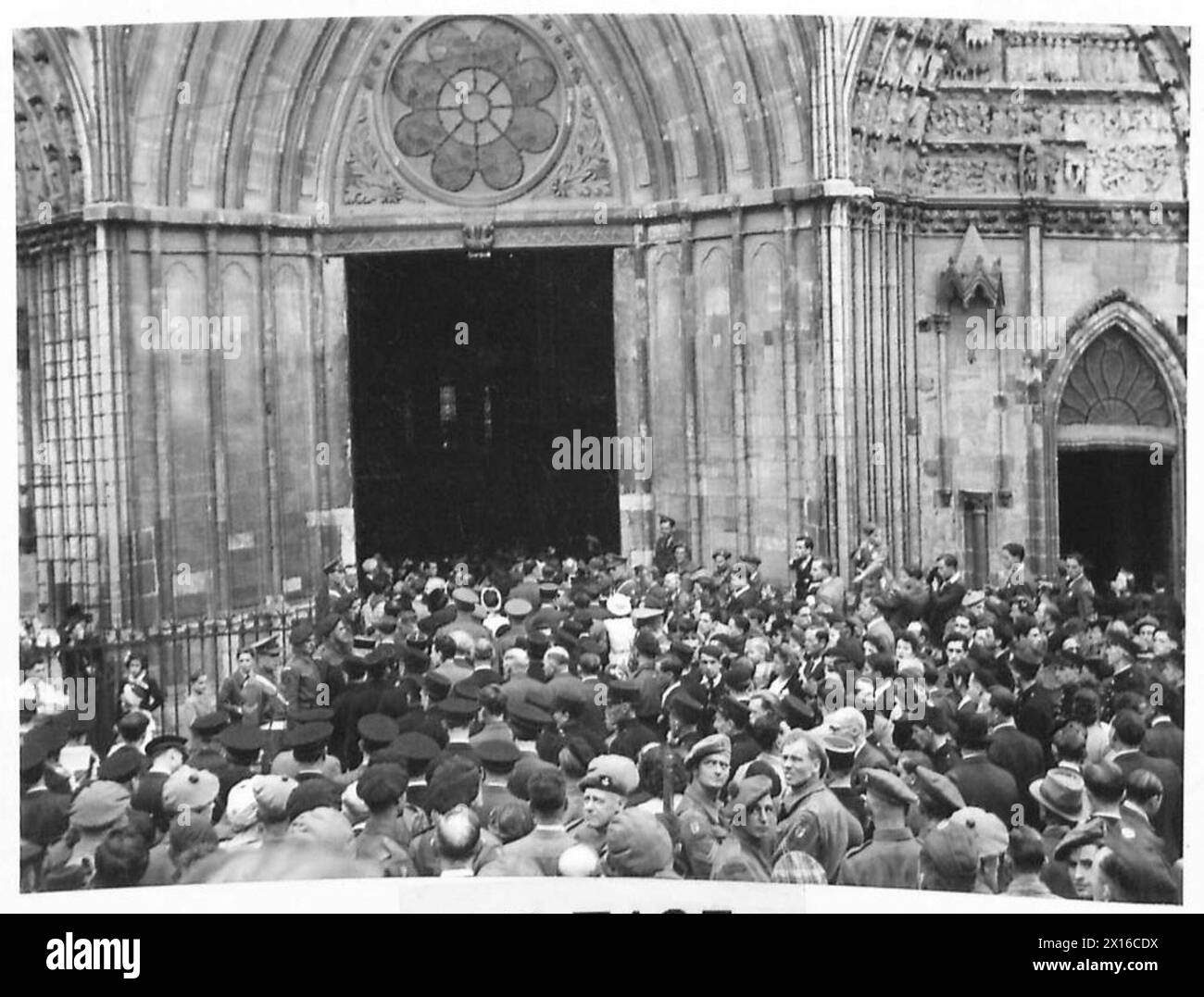 French civilians gather outside Bayeux Cathedral for a service while ...