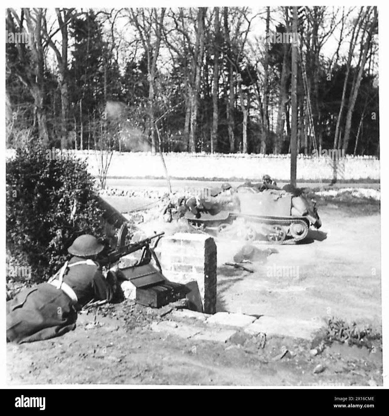 SPARTAN EXERCISE - A Bren gunner, concealed behind a wall, shoots up an ...