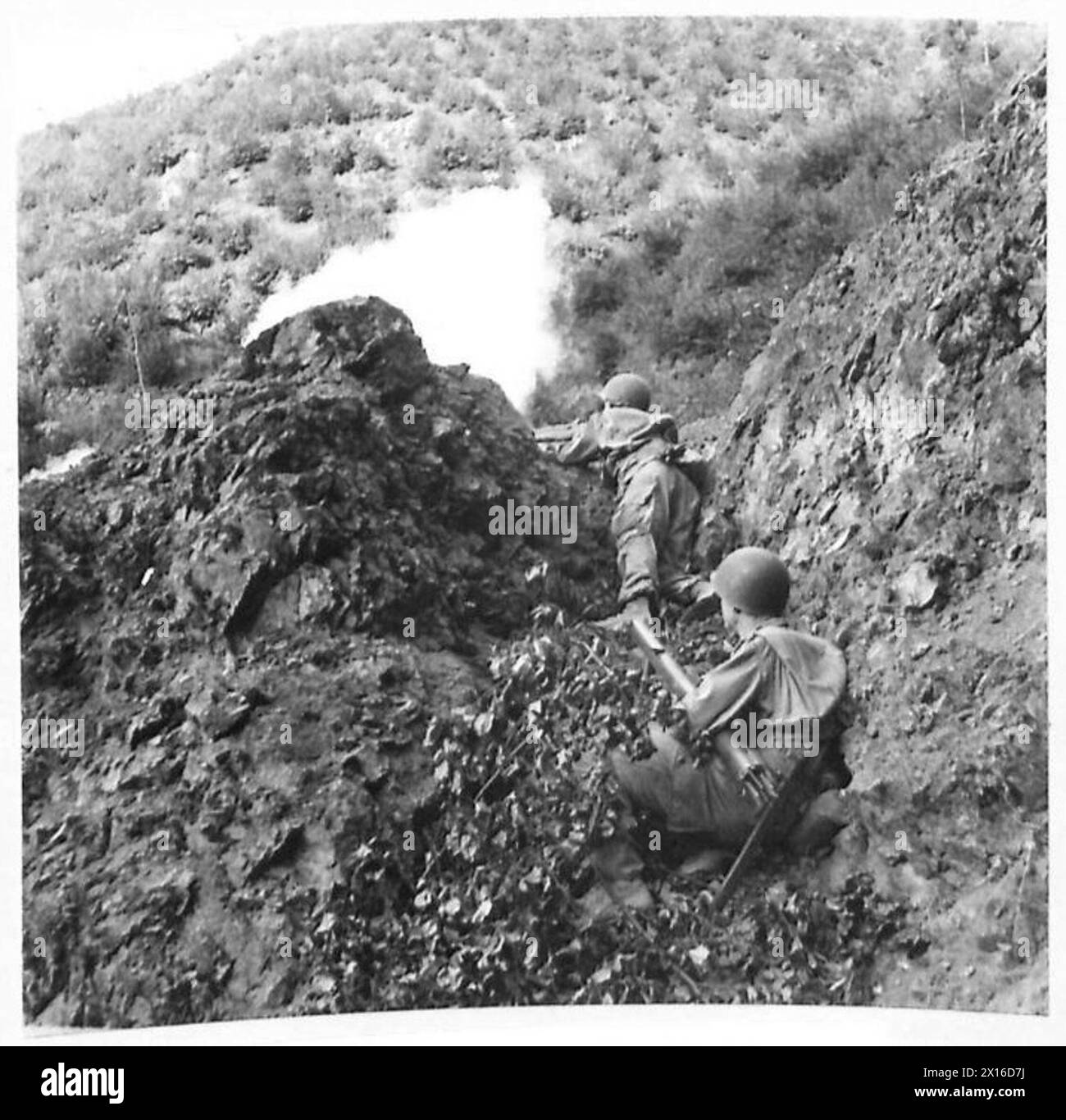 American Airborne rifleman and bazooka-gunner clear the advance for the ...