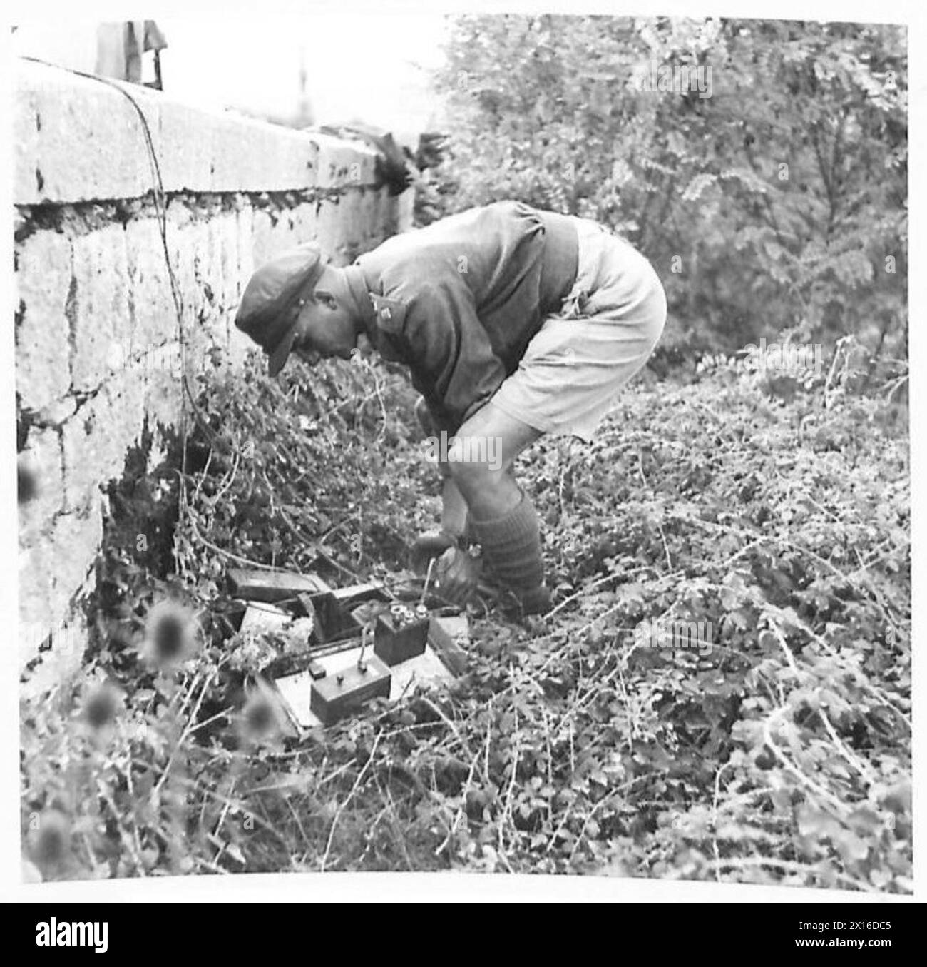 Lieut. Harris of Bexhill operates the plunger of an explosive device ...