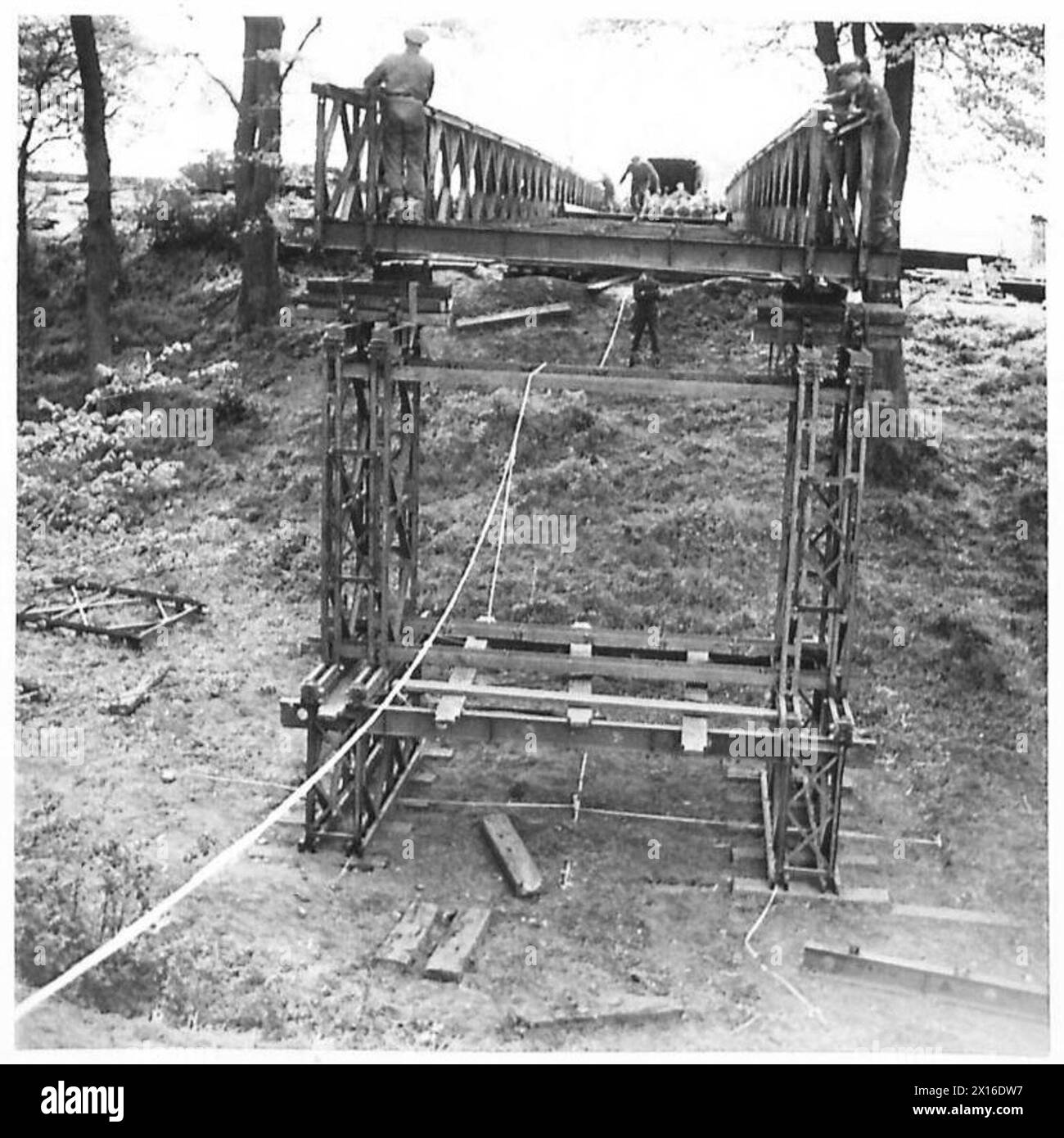 ERECTING A BAILEY BRIDGE - Bridge half-way down , British Army Stock ...