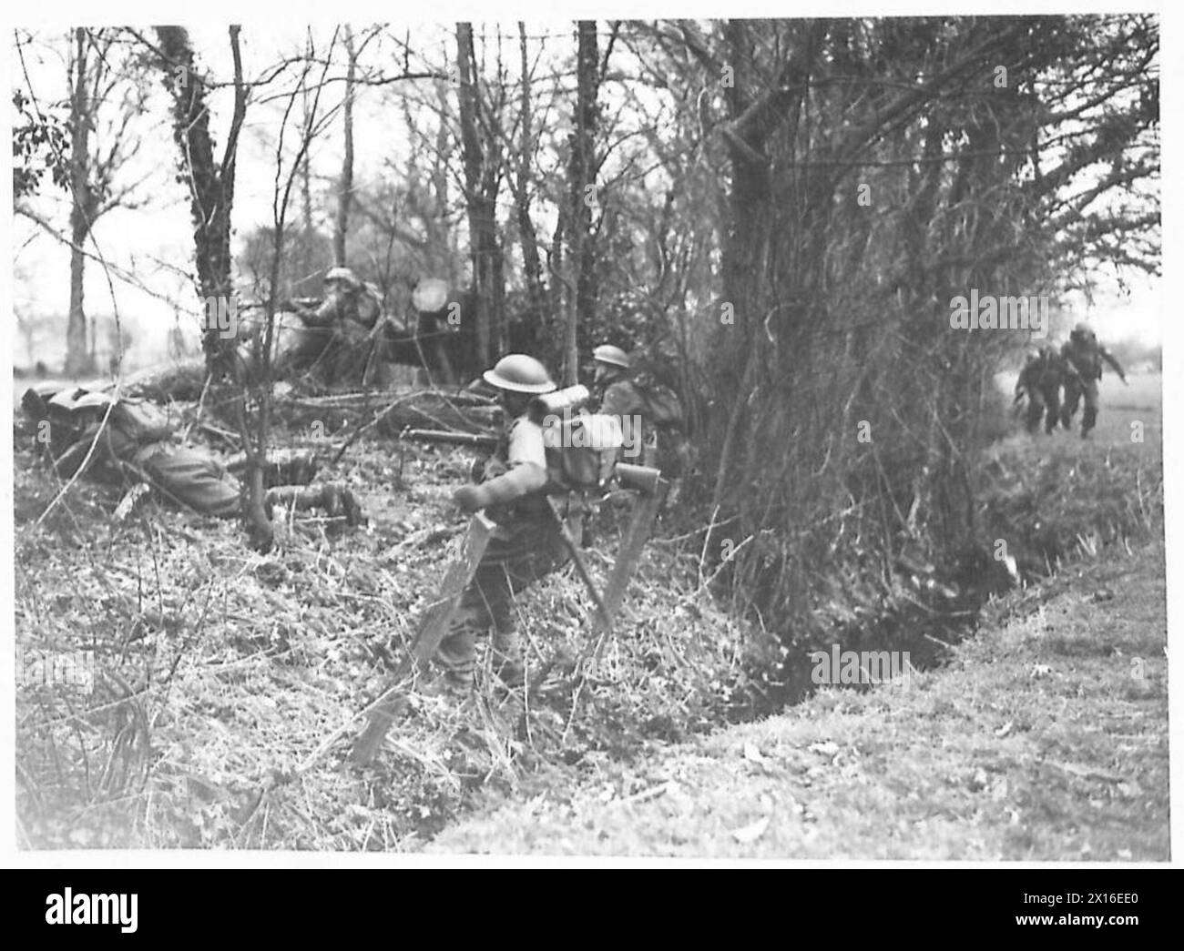 THE NORTHAMPTONSHIRES ARE READY - A patrol going into action in a wood ...