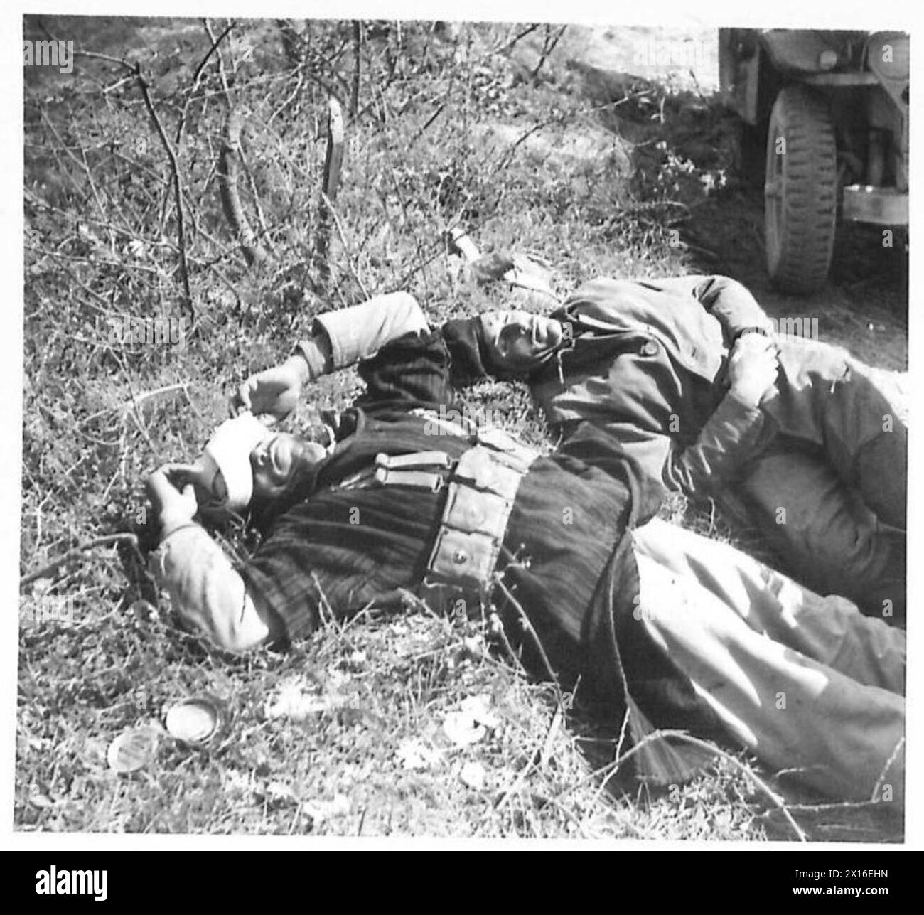 Two jeep drivers, one British and one Goumier, rest under the sun while ...