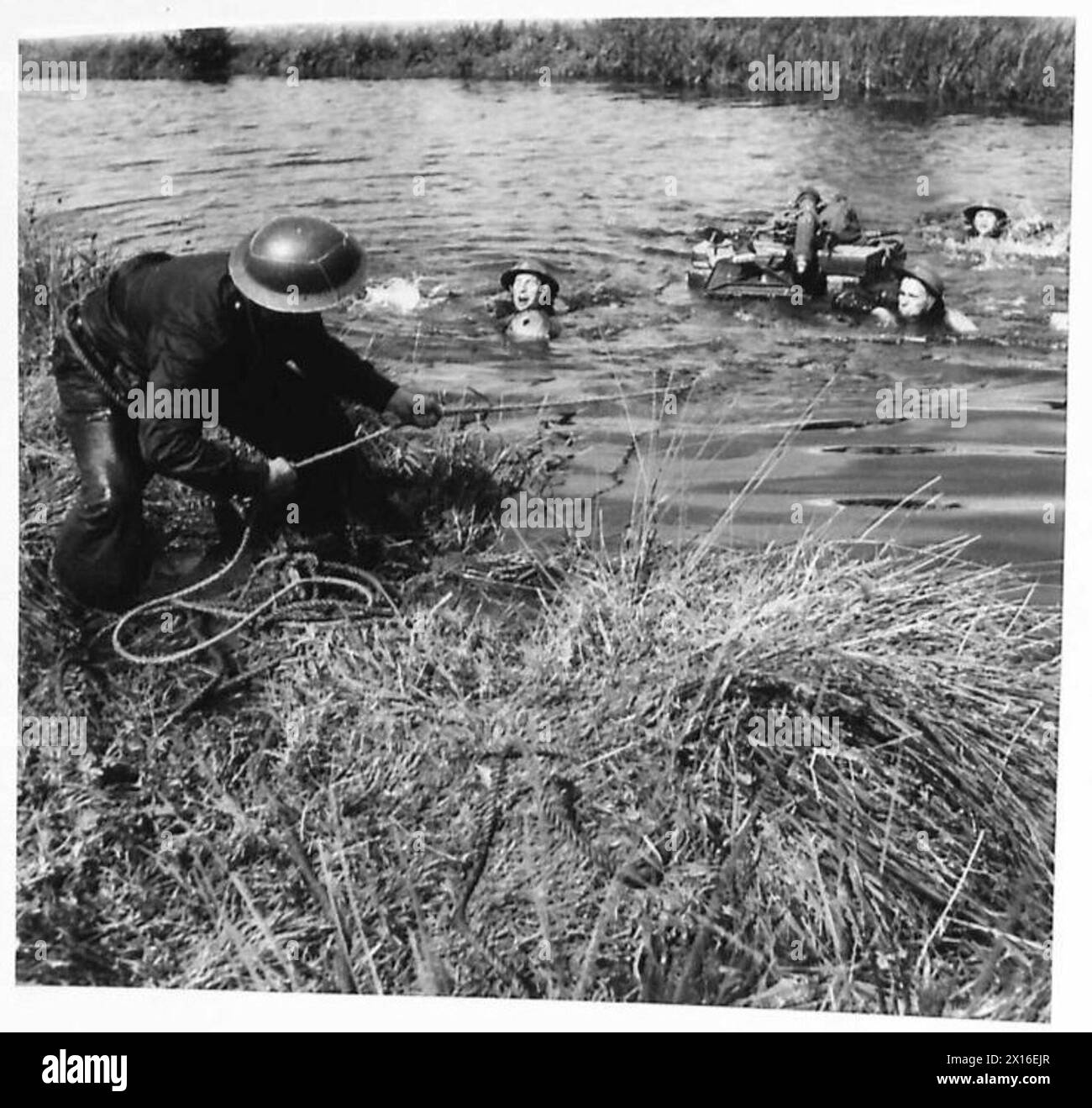 IMPROVISATION - Troops swimming across a river pulling a raft carrying ...