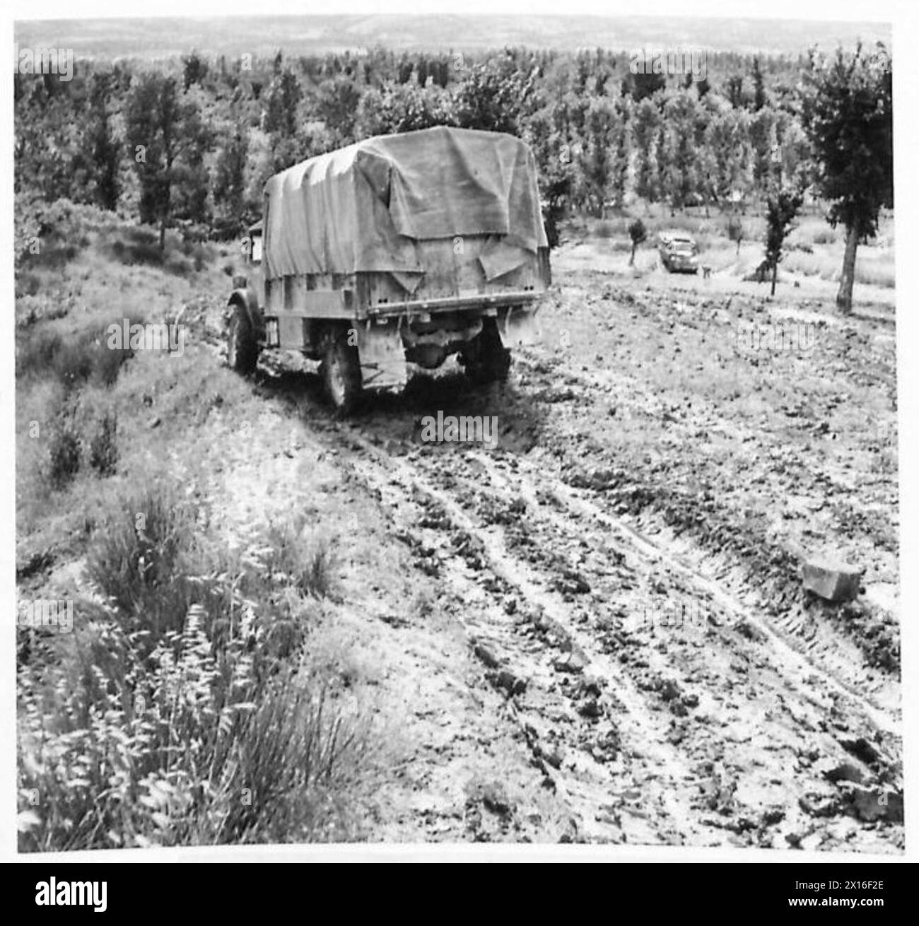 Transport vehicles slip on a muddy diversion caused by heavy rains ...