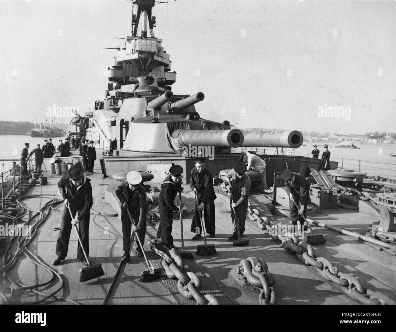 A working party aboard HMS Revenge cleans the focsle during World War ...