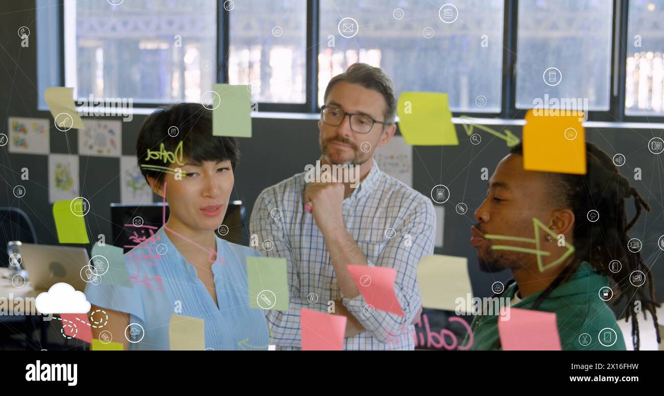 Image of connected icons over diverse colleagues brainstorming over ...