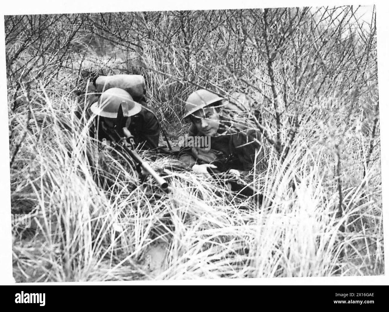 A Belgian Bren gunner conducts training exercises under cover to ...