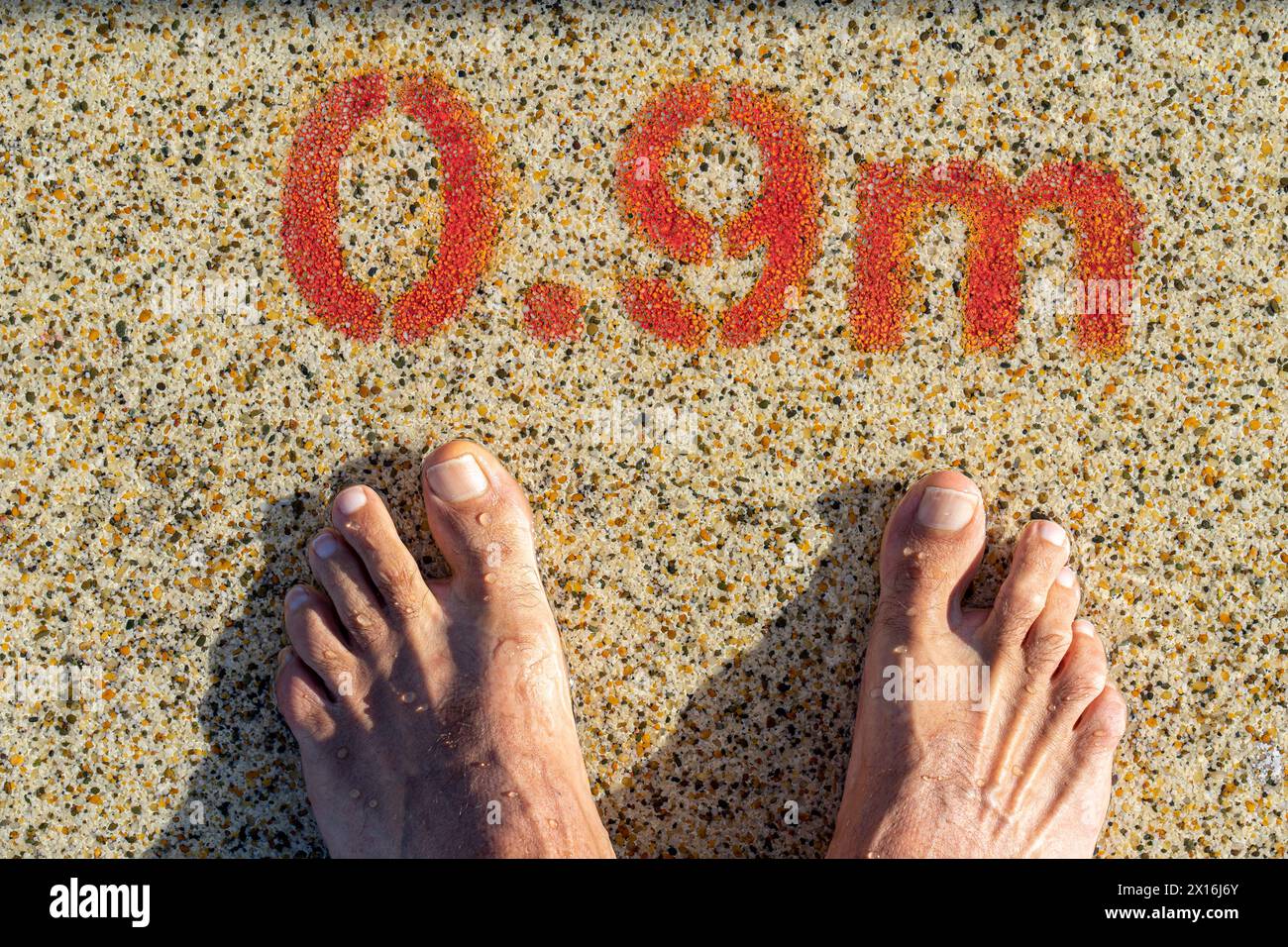 two feet at the pool entrance with a depth indication of 0.9 meters ...