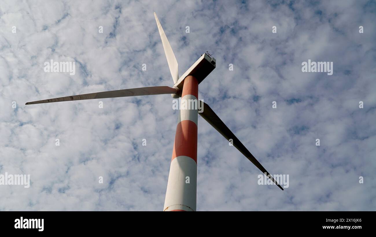 Wind turbine against sky backdrop: sustainable energy symbol Stock ...