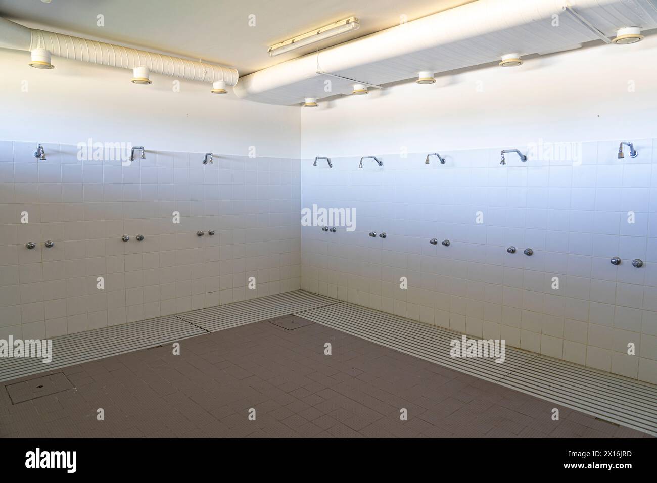 Changing rooms in the shower area with white tile wall Stock Photo - Alamy