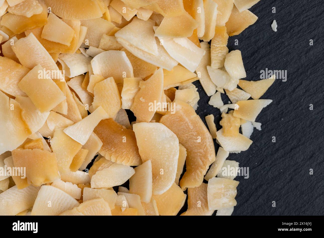 thin coconut flakes fried in sugar syrup , sweet orange and yellow ...