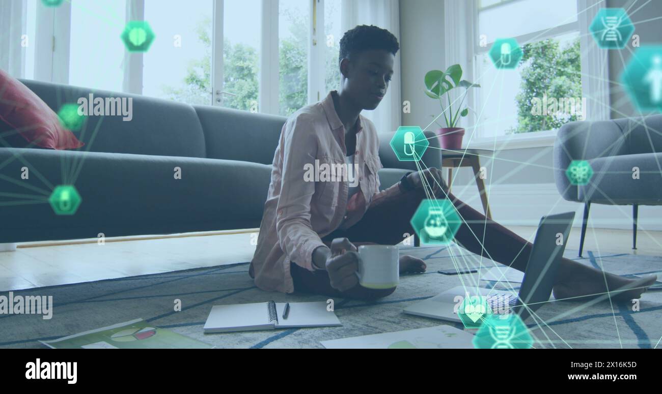 Image of network of connections with icons over african american woman ...