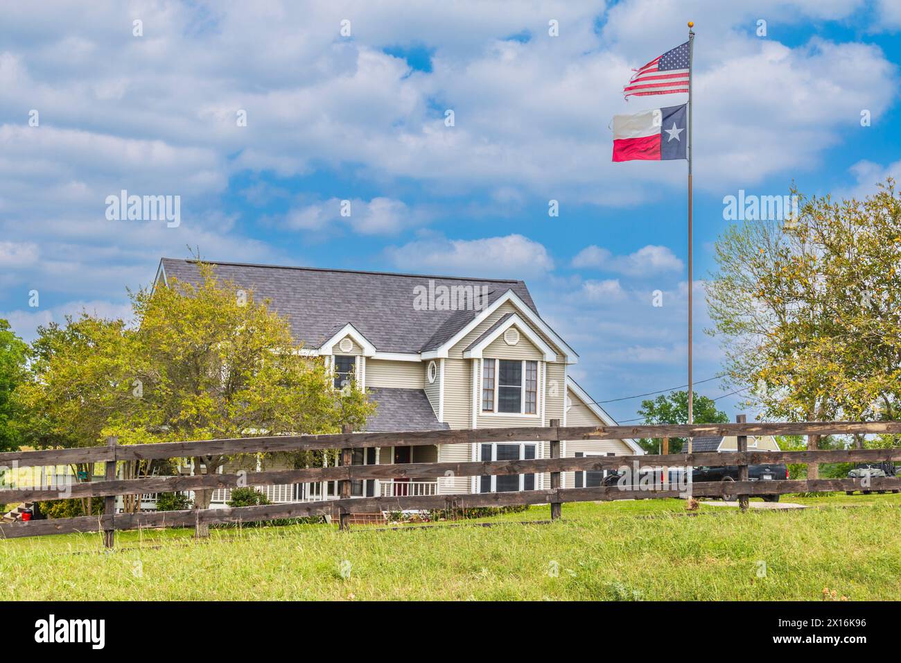 US flag and Texas flag flying at entrance to rural Texas homestead ...