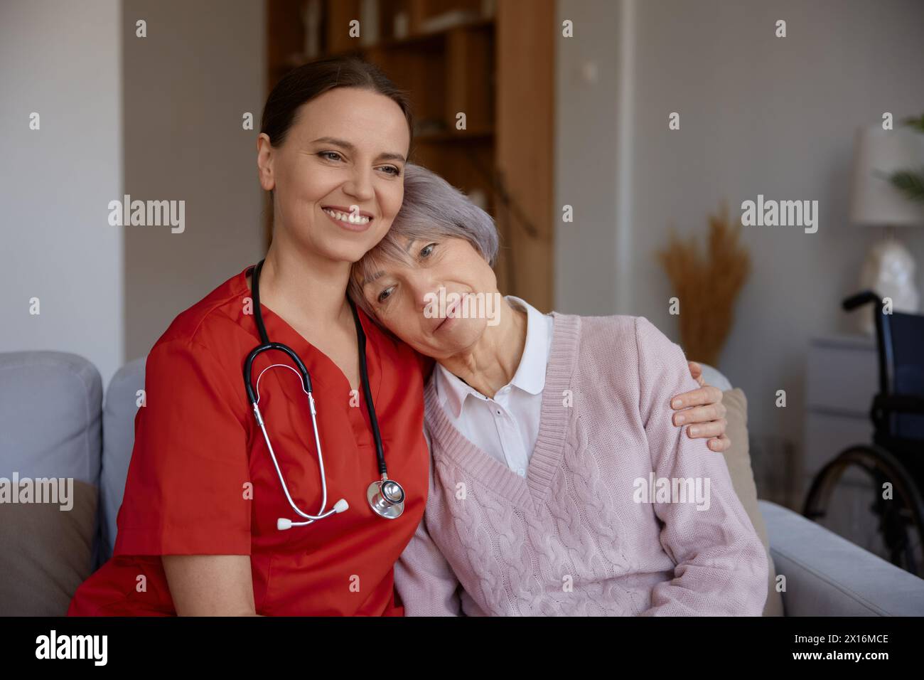 Smiling happily caregiver hugging her old lady patient portrait Stock ...