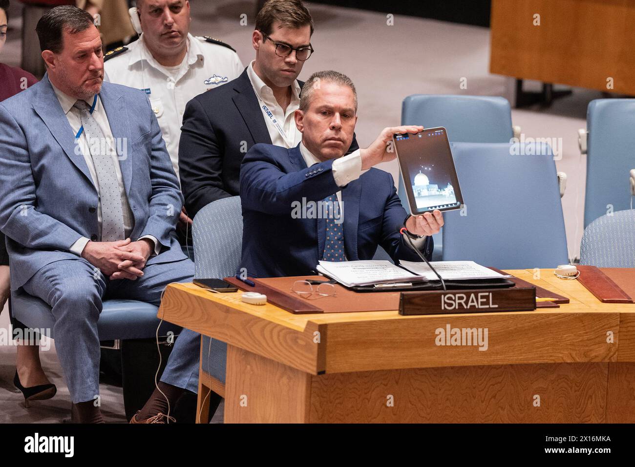 Ambassador Gilad Erdan of Israel speaks while showing a video of an ...