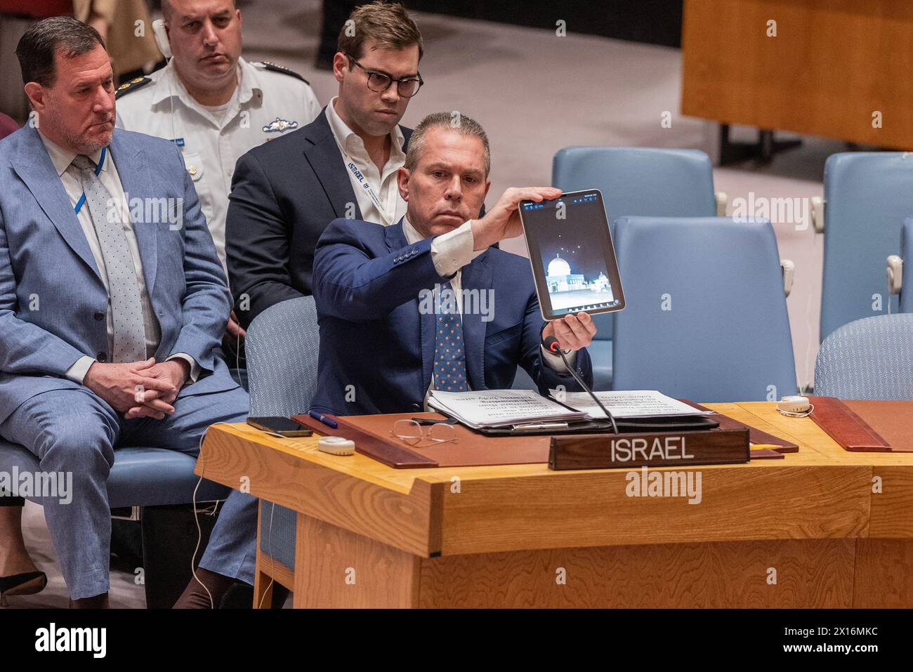 Ambassador Gilad Erdan of Israel speaks while showing a video of an ...