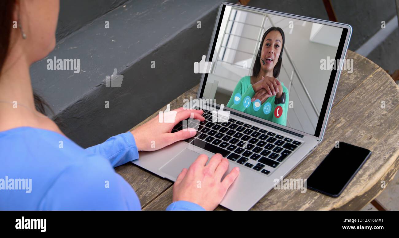 Image of media icons over caucasian woman having laptop image call with biracial colleague Stock ...