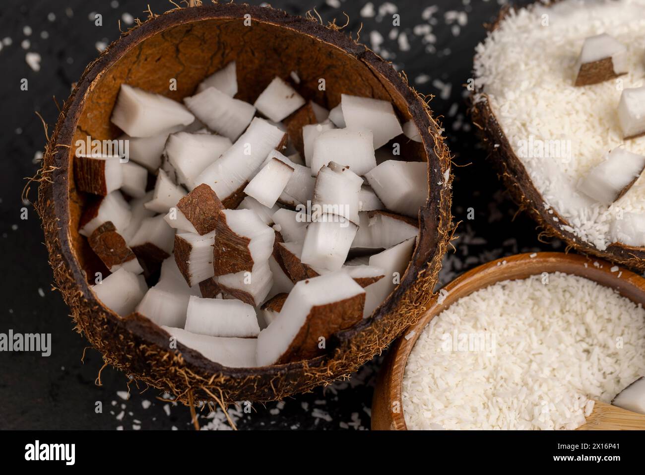 white coconut pulp and dried coconut flakes, a close-up of which is ...
