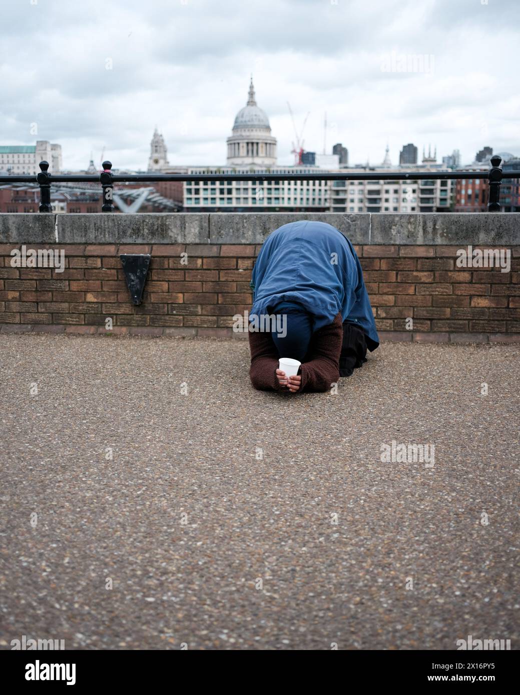 A man begging in London on the South Bank near St Pauls cathederal ...