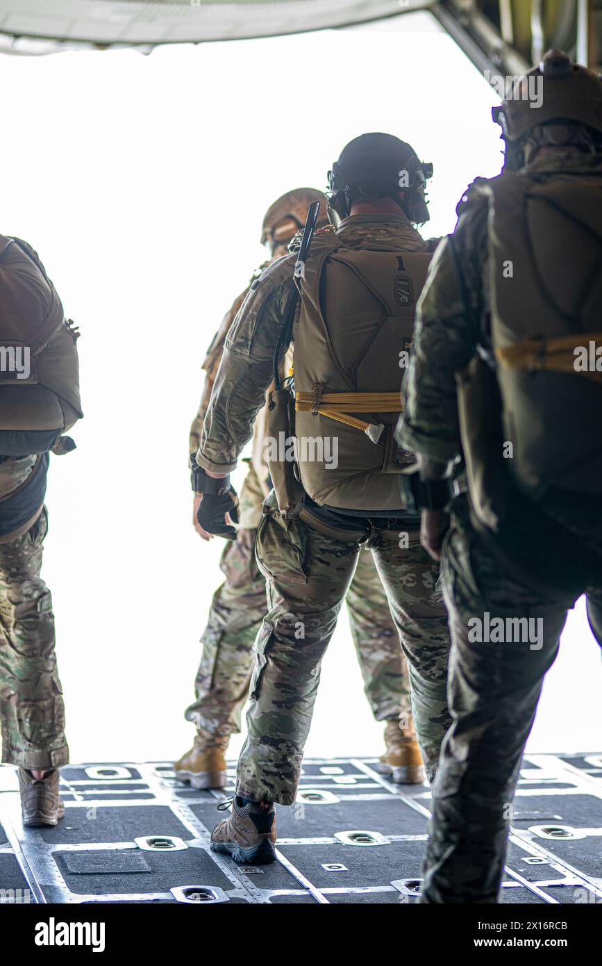 A group of soldiers are on a plane, one of them is wearing a backpack ...