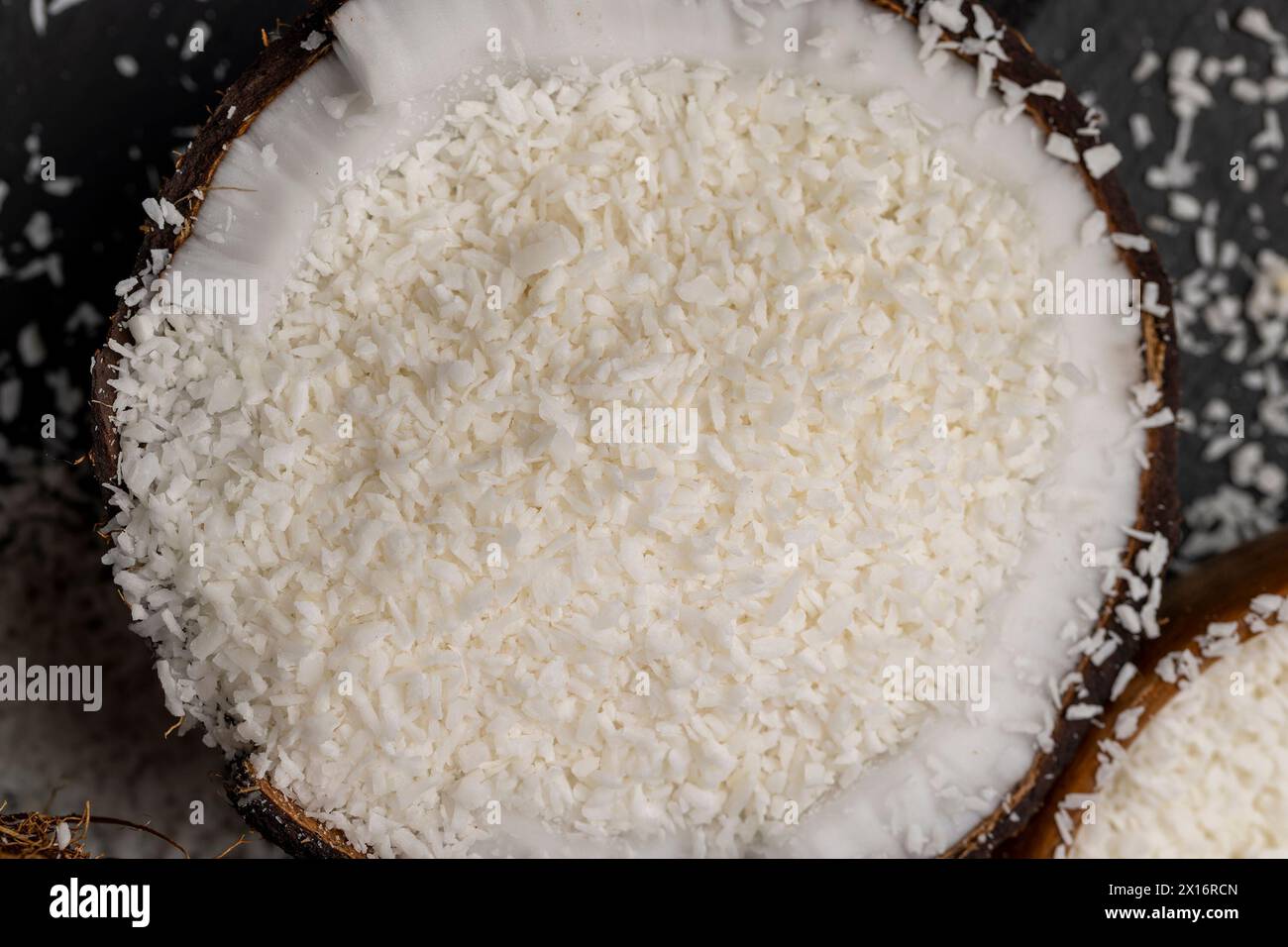 white coconut pulp and dried coconut flakes, a close-up of which is ...