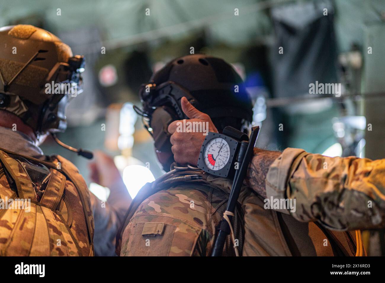 Two soldiers are standing next to each other, one of them giving a ...