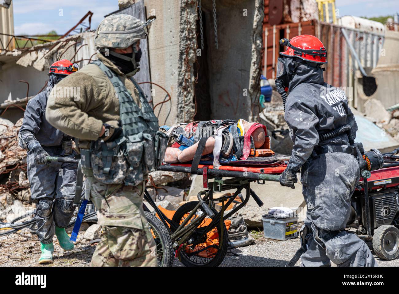 A group of people in hazmat suits are carrying a person on a stretcher ...