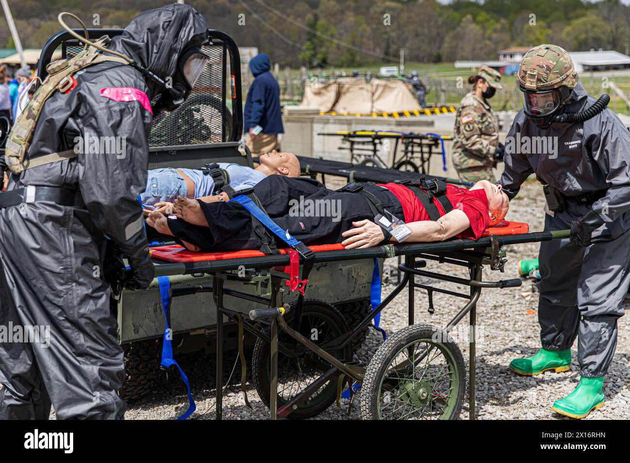 A man in a hazmat suit is helping to move a man on a stretcher Stock ...