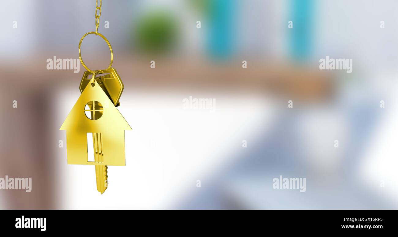 Image of gold house key fob and key dangling over out of focus ...
