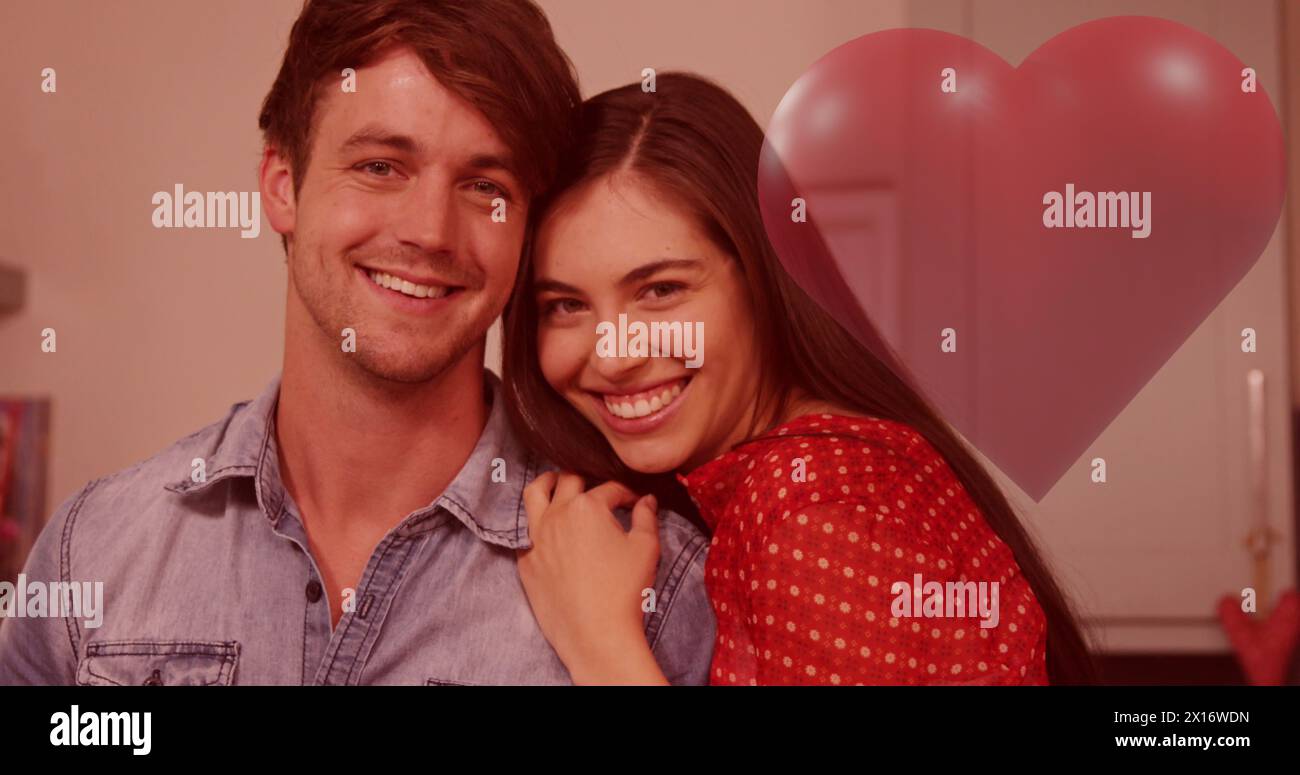 Image of red heart over couple in love smiling Stock Photo - Alamy