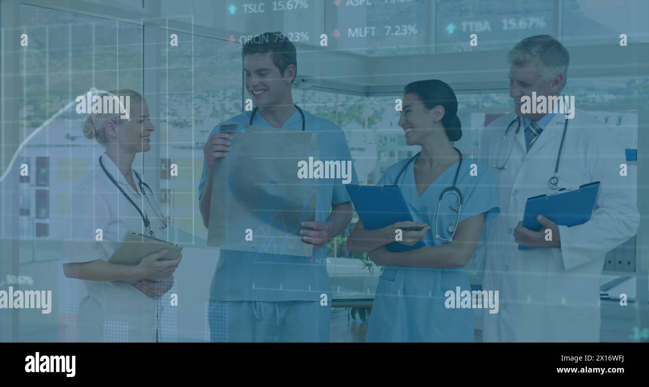 Image of stock market data processing over team of diverse doctors ...