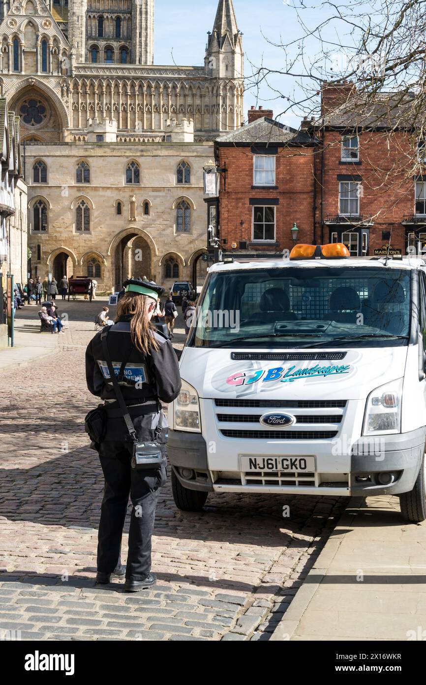 Parking enforcement officer checking vehicle on Castle Hill, Lincoln ...