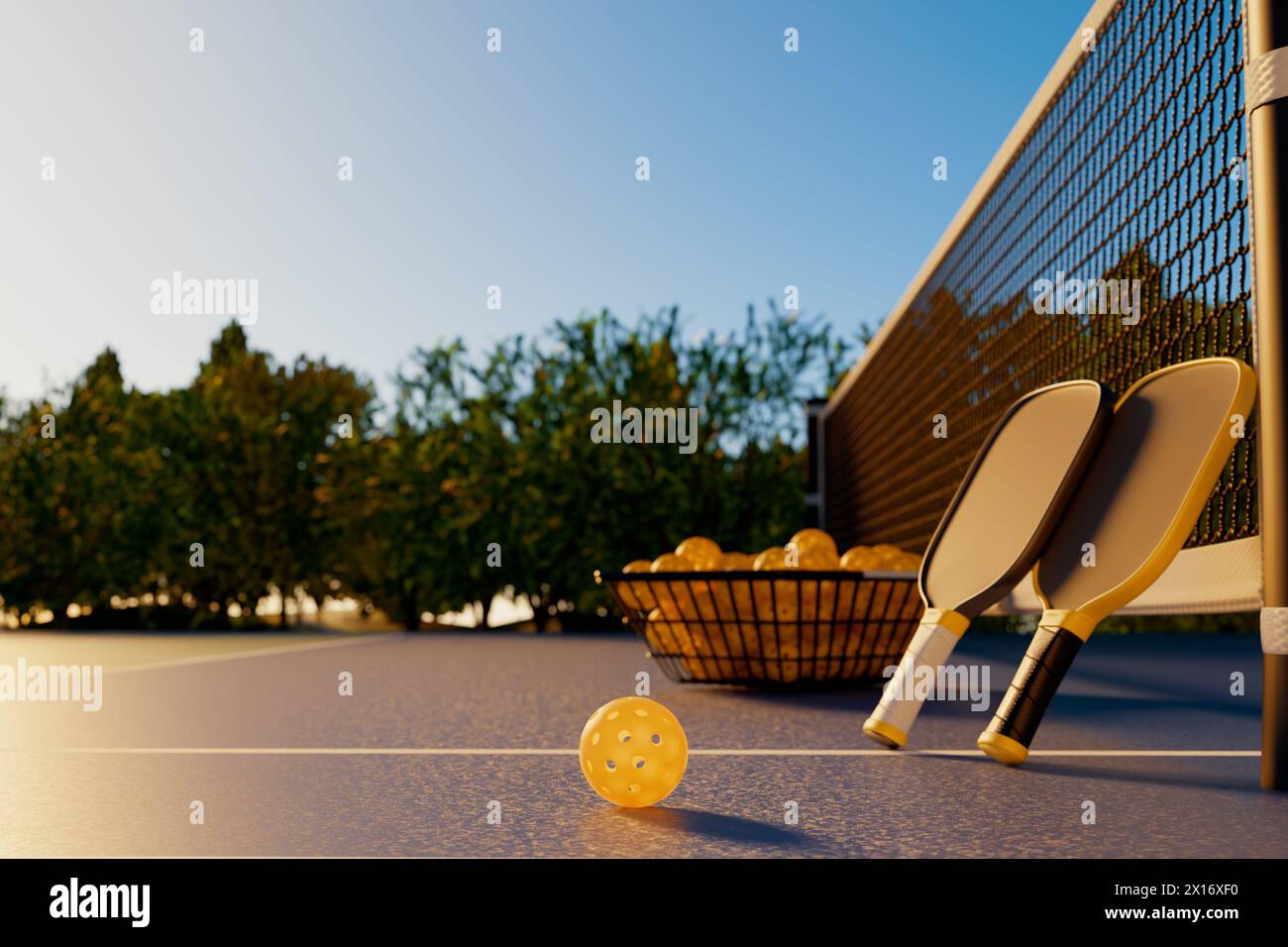 Pickleball racket and balls in a basket outdoors on a sport court in ...