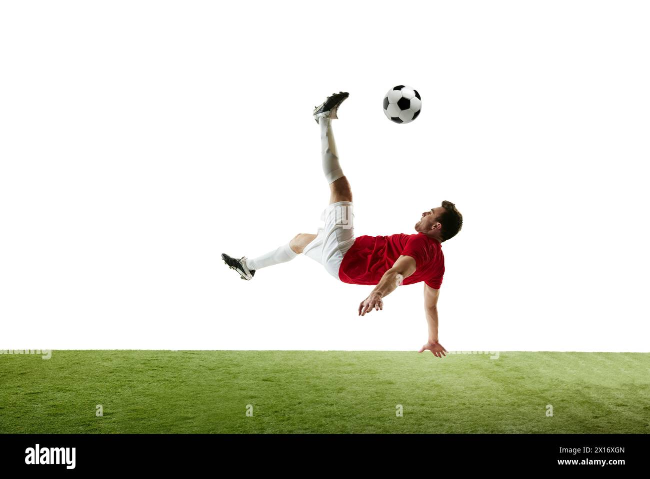 Young man, soccer player in motions during game, training, hitting ball ...