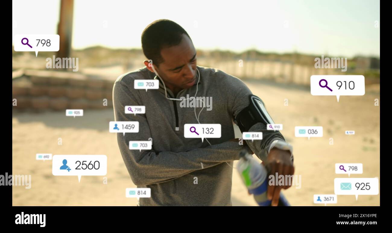 Image of notification bars, biracial man adjusting phone on arm and using smartwatch Stock Photo ...