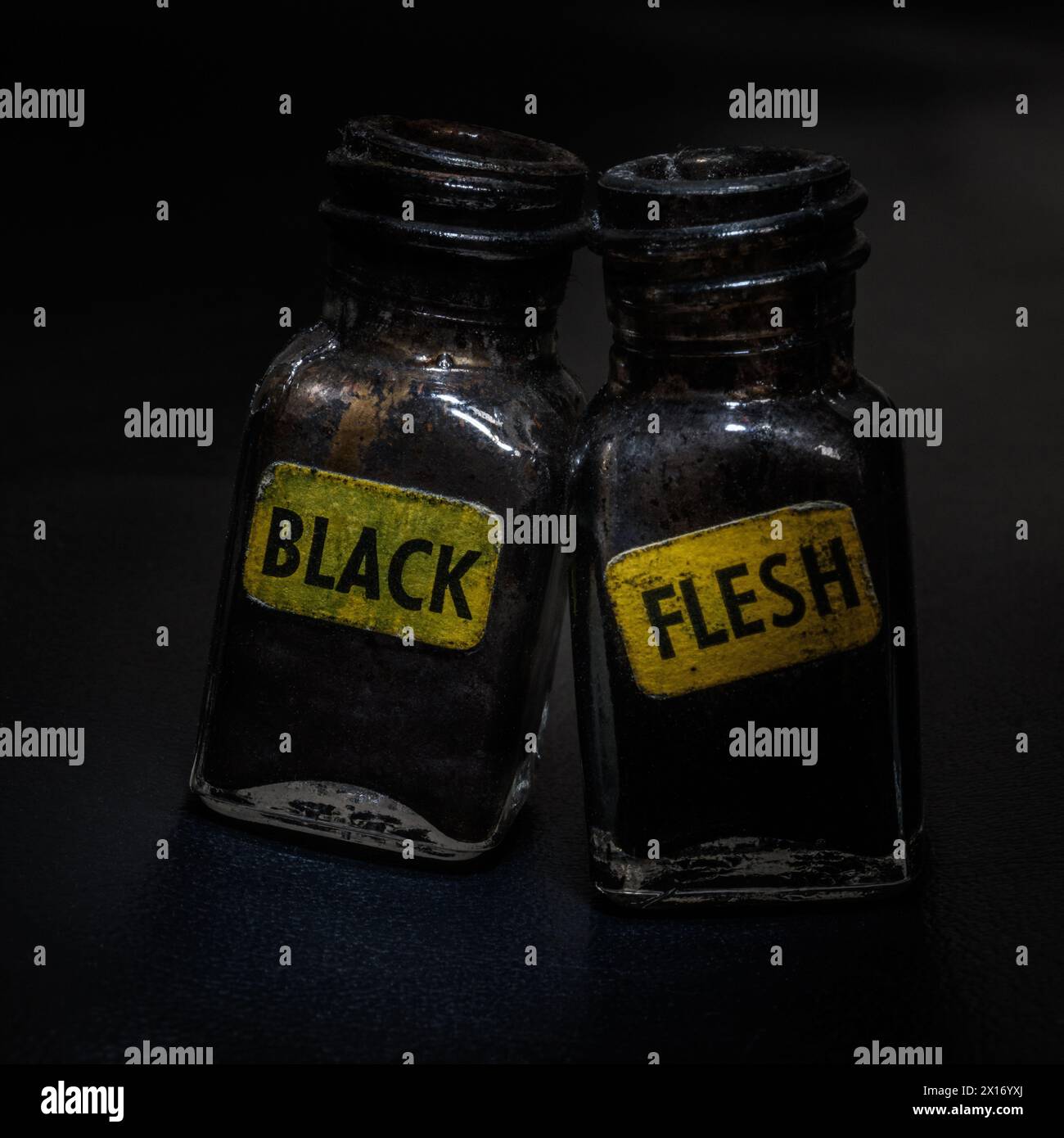 two bottles of dried ink with labels flesh & black Stock Photo - Alamy
