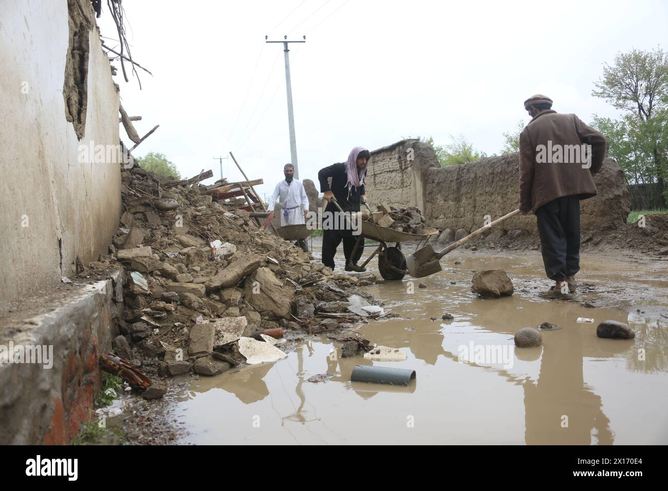 Parwan. 15th Apr, 2024. People clear the ruins of a dwelling destroyed ...