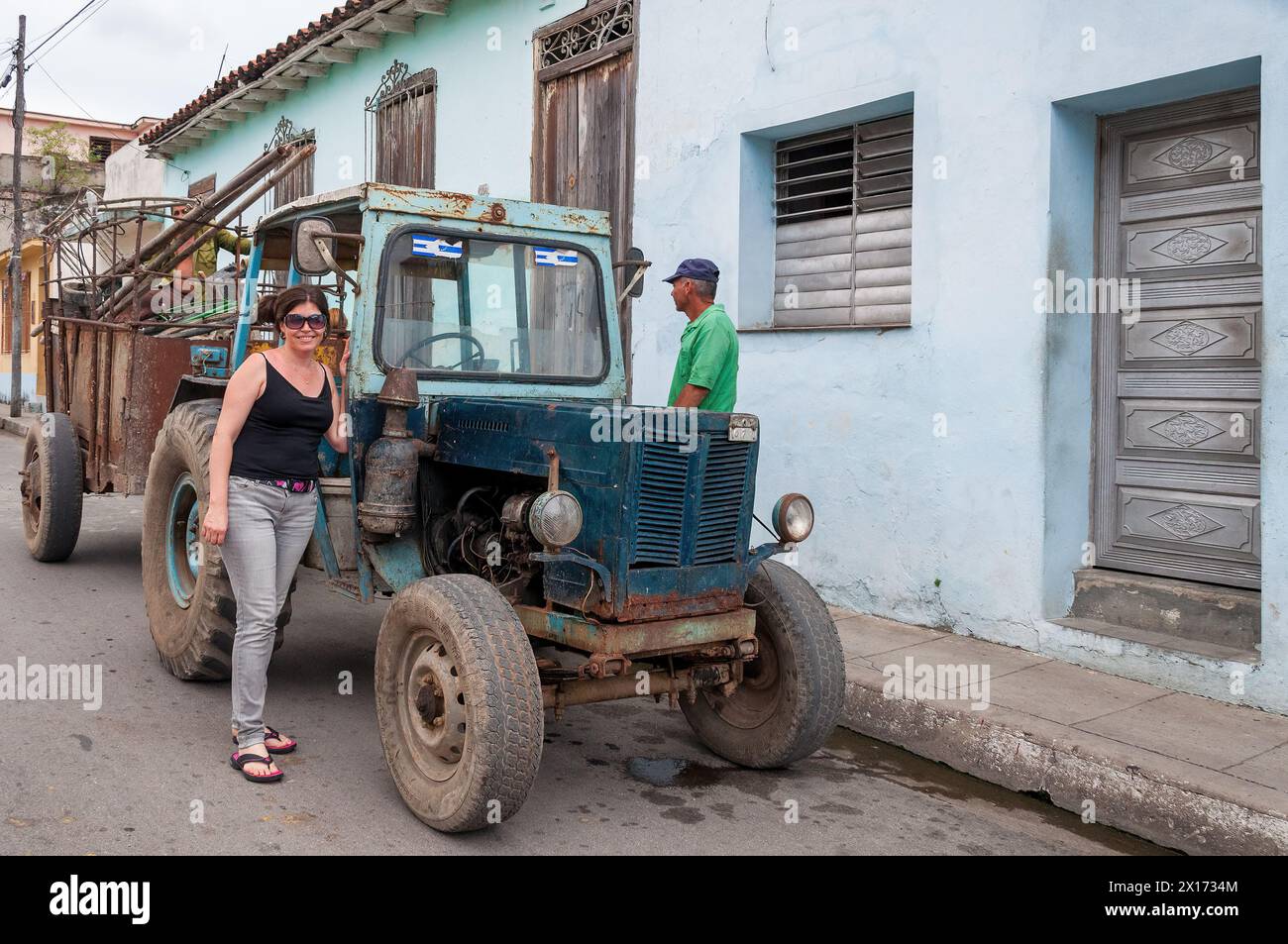 Tourist portrait by obsolete agricultural tractor. Portrait of real ...