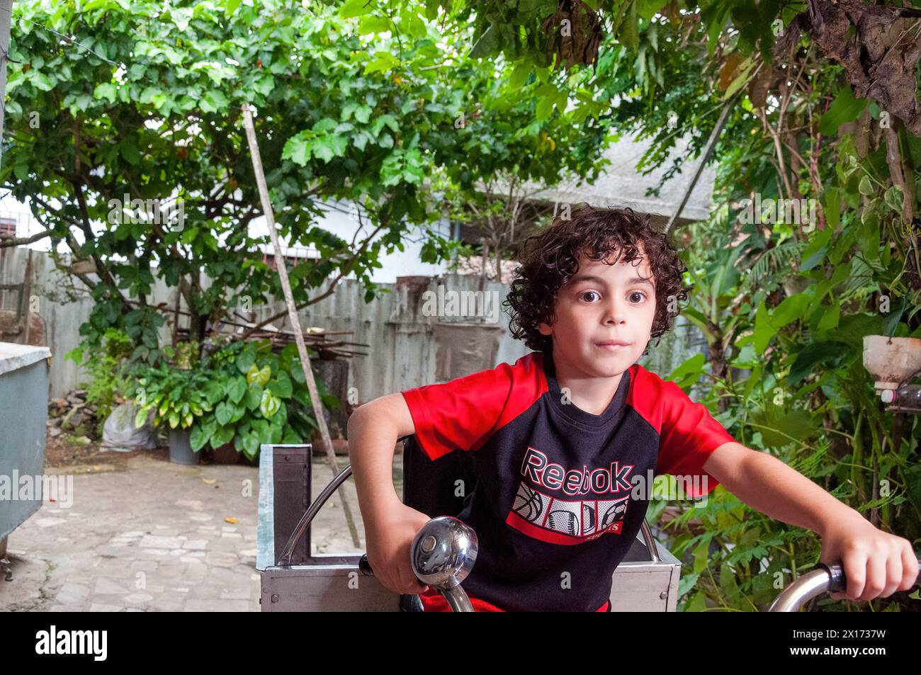 Child boy playing with tricycle. Portrait of real Cuban people Stock ...