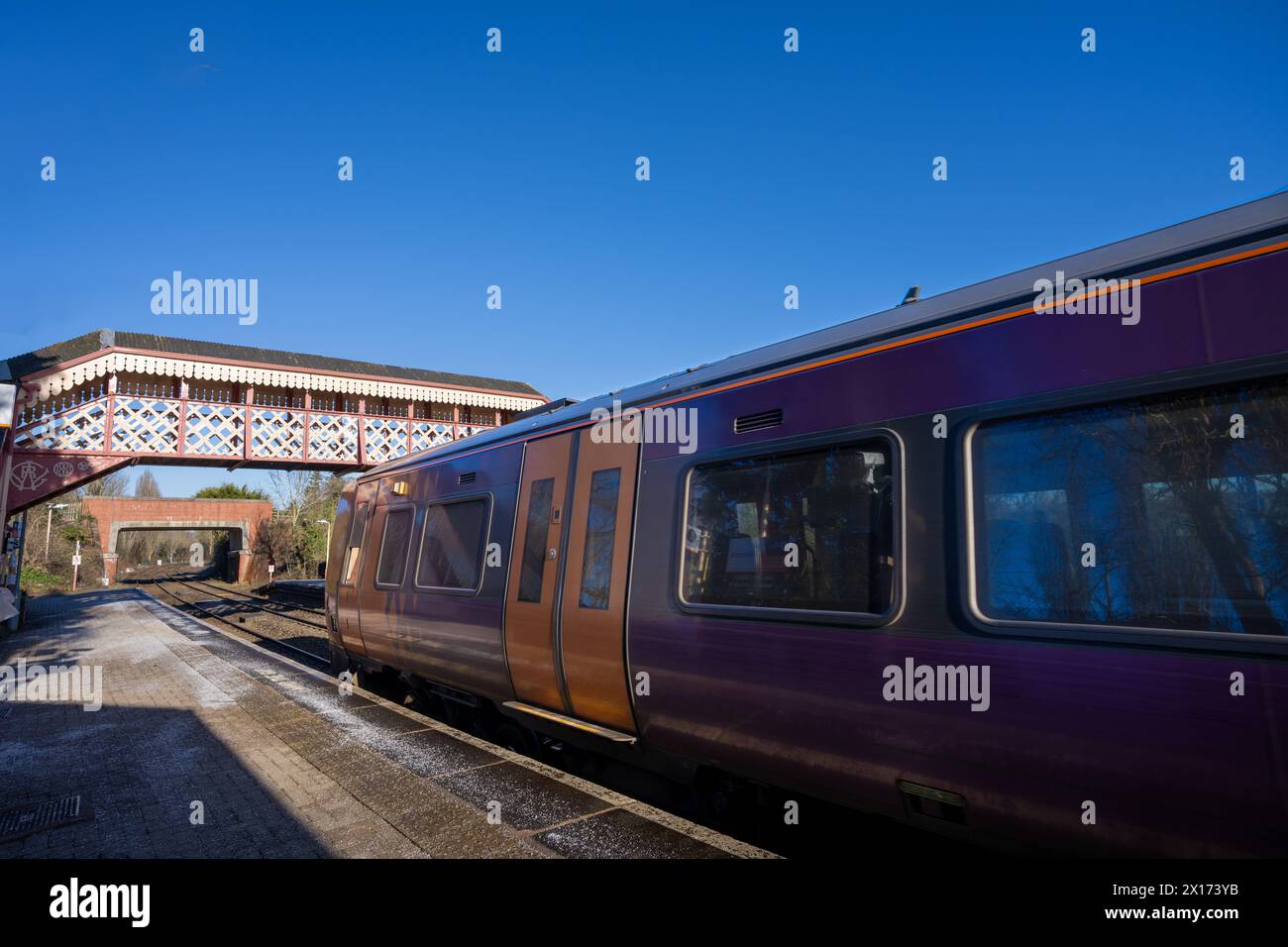 West Midlands train at country station with old passenger bridge in ...