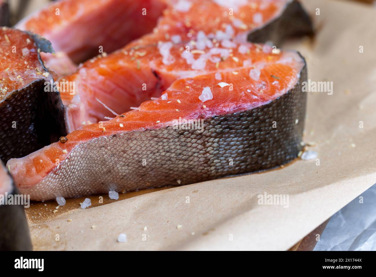 red trout meat in the kitchen, cooking a fish dish with expensive red ...