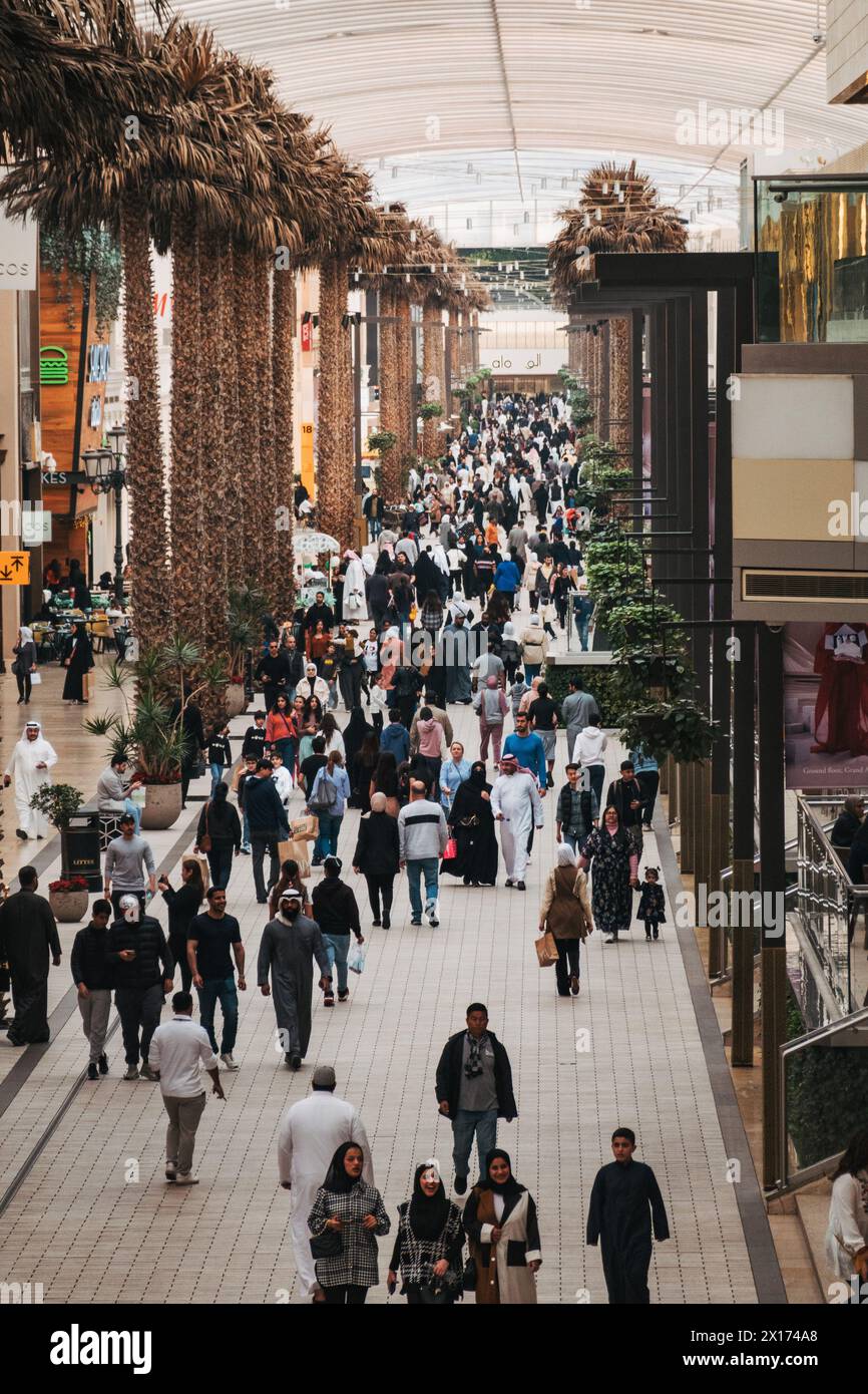 palm trees line a busy street inside The Avenues, the largest shopping ...