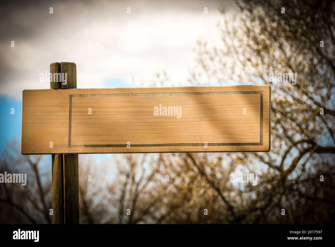 empty wooden post and sign, free to write on, in the middle of the ...