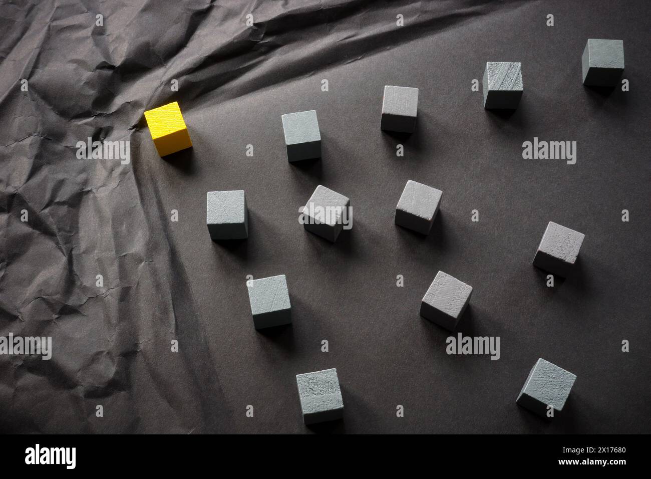 Crumpled paper and a yellow cube as a leader overcomes obstacles Stock ...