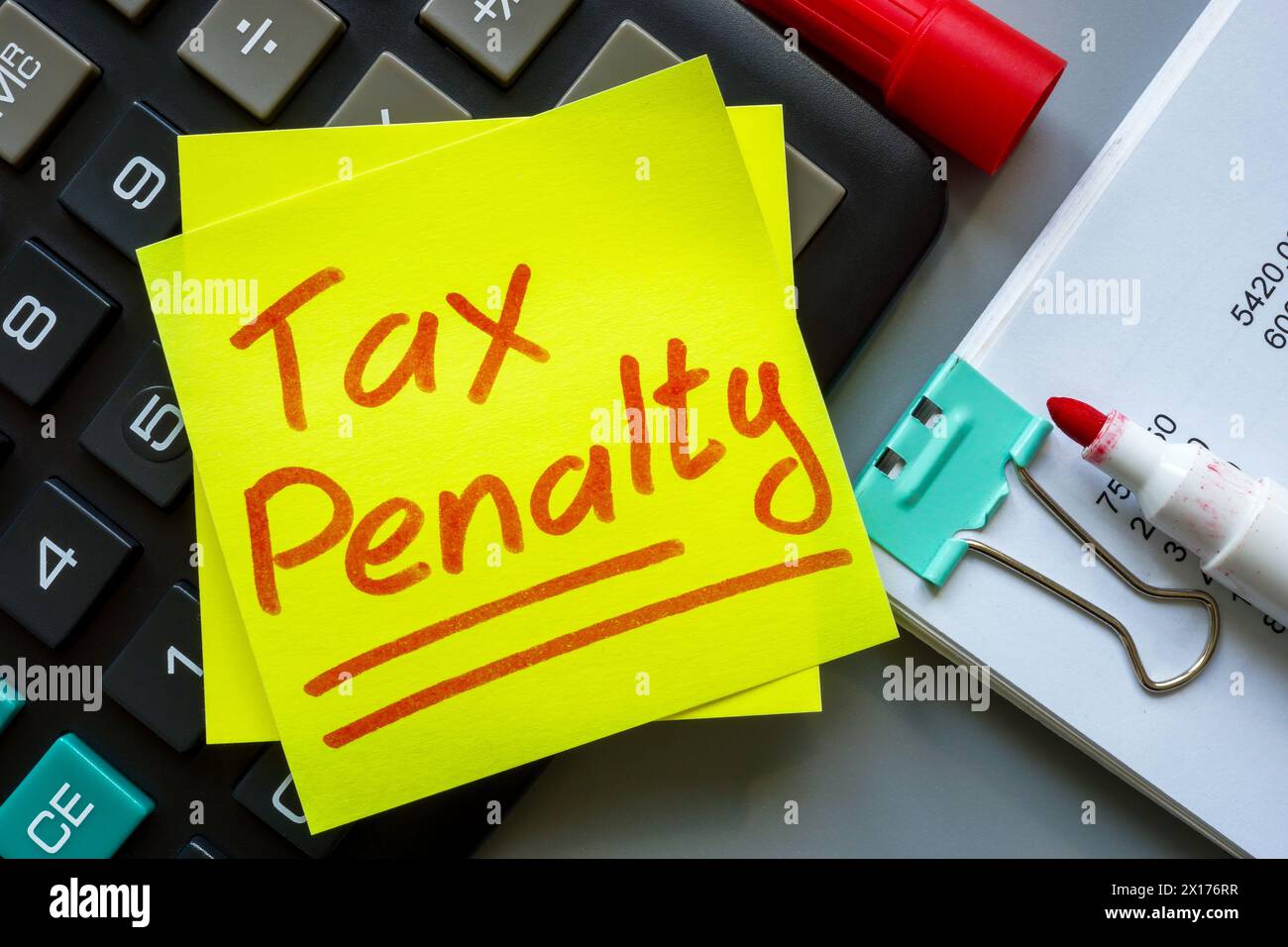 Tax penalty concept. Calculator with a sticker on it Stock Photo - Alamy