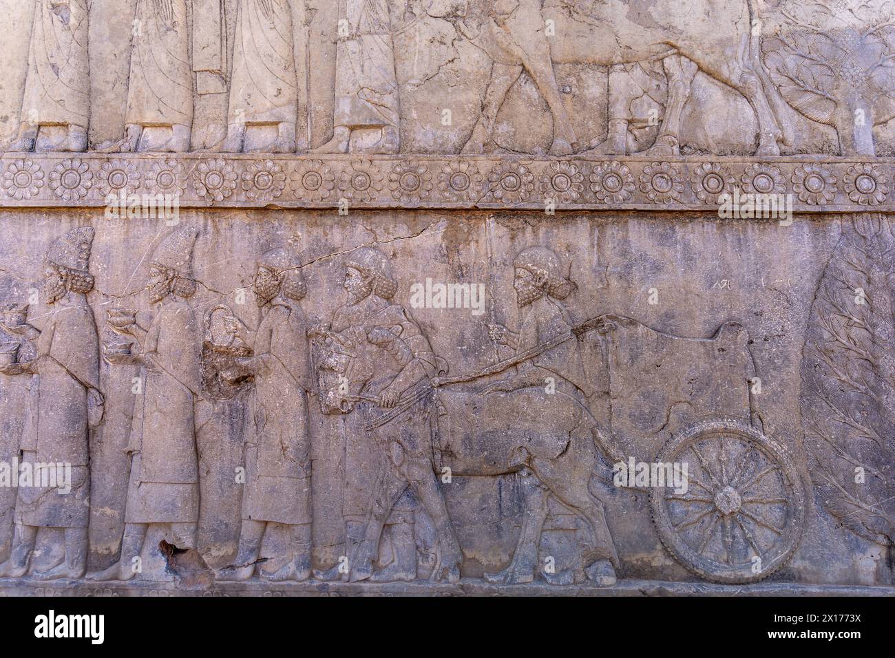 Detailed stone engravings depicting people and animals in motion. A ...