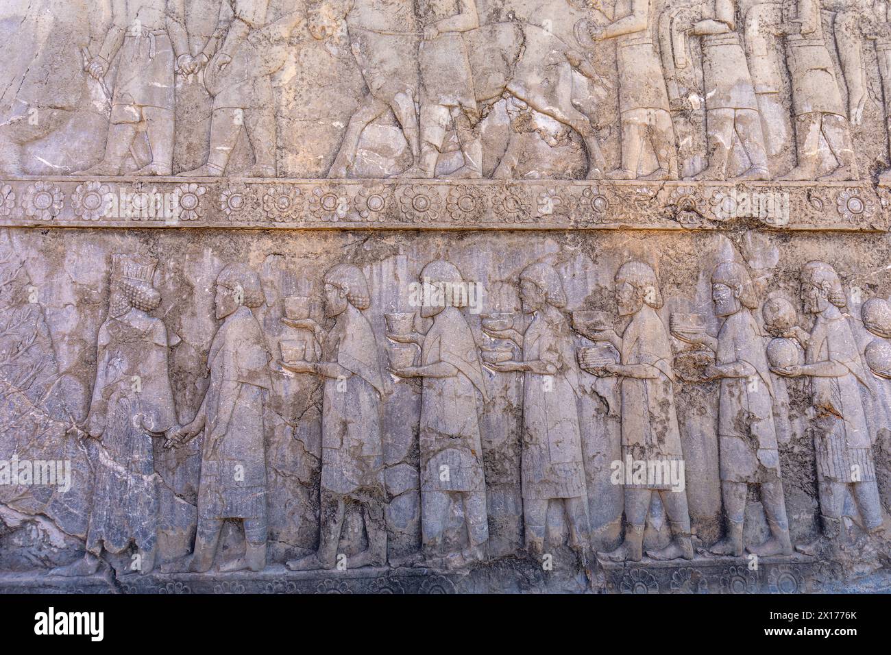 Detailed stone engravings depicting people and animals in motion. A ...