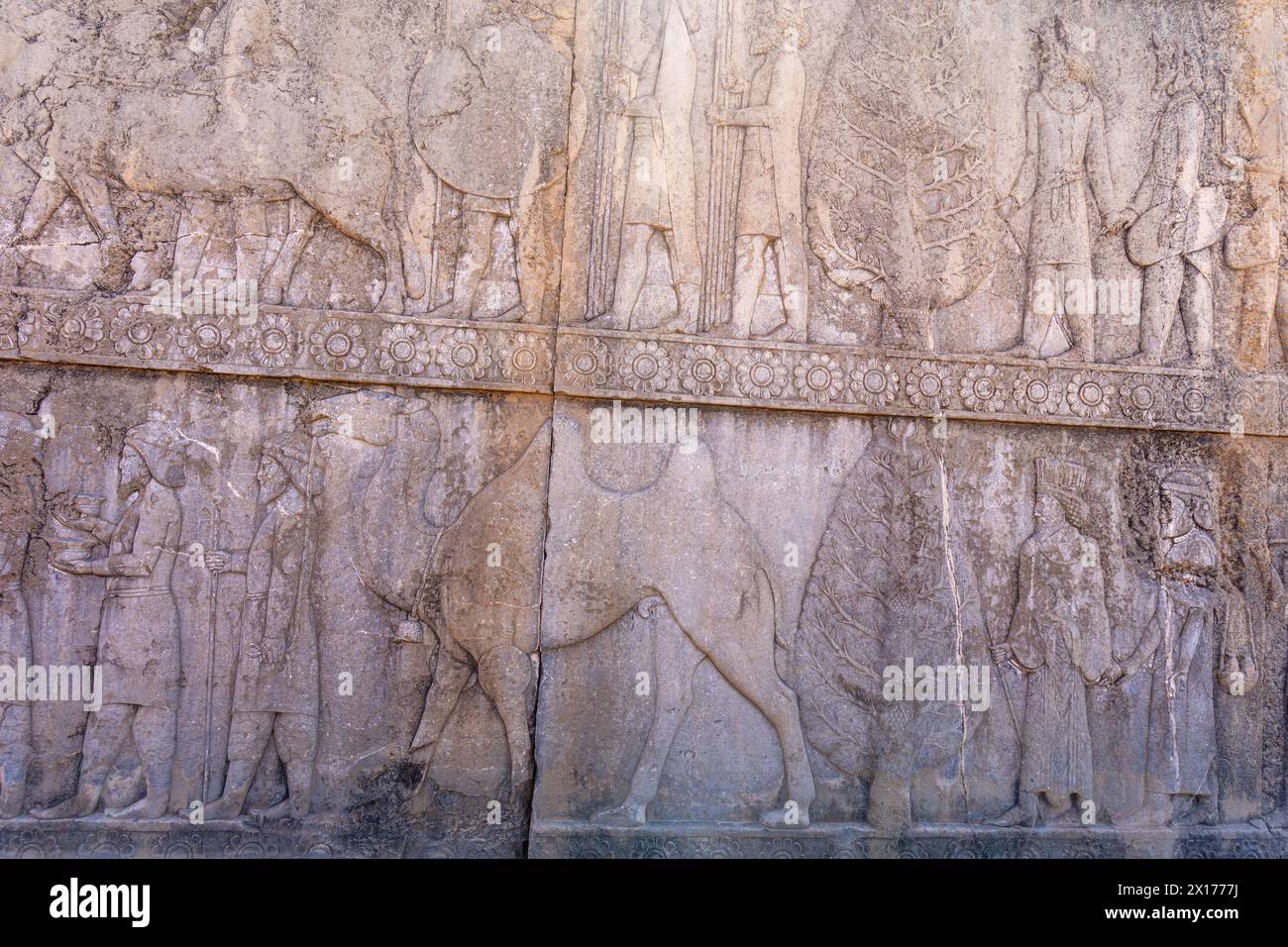 Detailed stone engravings depicting people and animals in motion. A ...